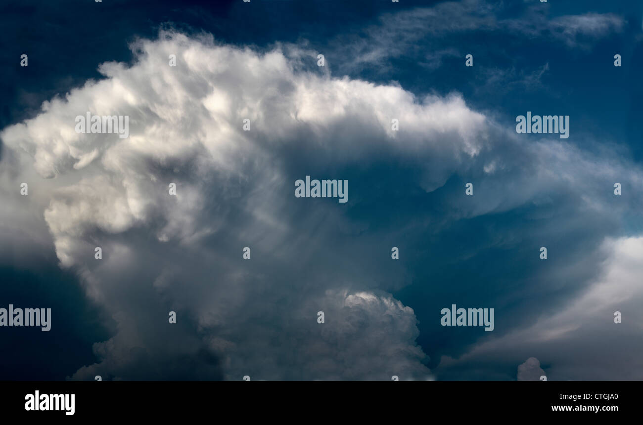 Sun rays skimming past a building anvil thunderhead in summer Stock ...