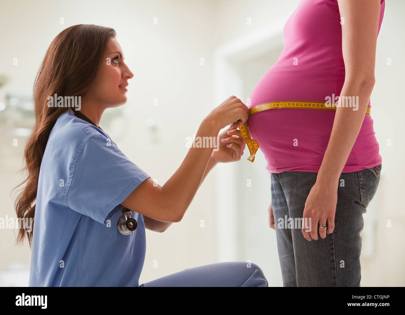 Nurse measuring pregnant woman's stomach Stock Photo - Alamy