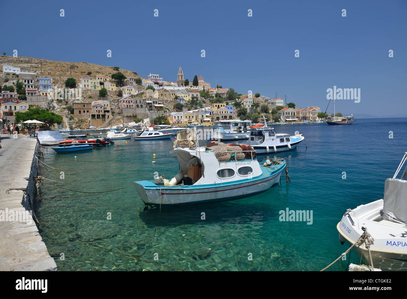 Some boats and the beautiful Harani quay in the port of Yialos; Symi ...