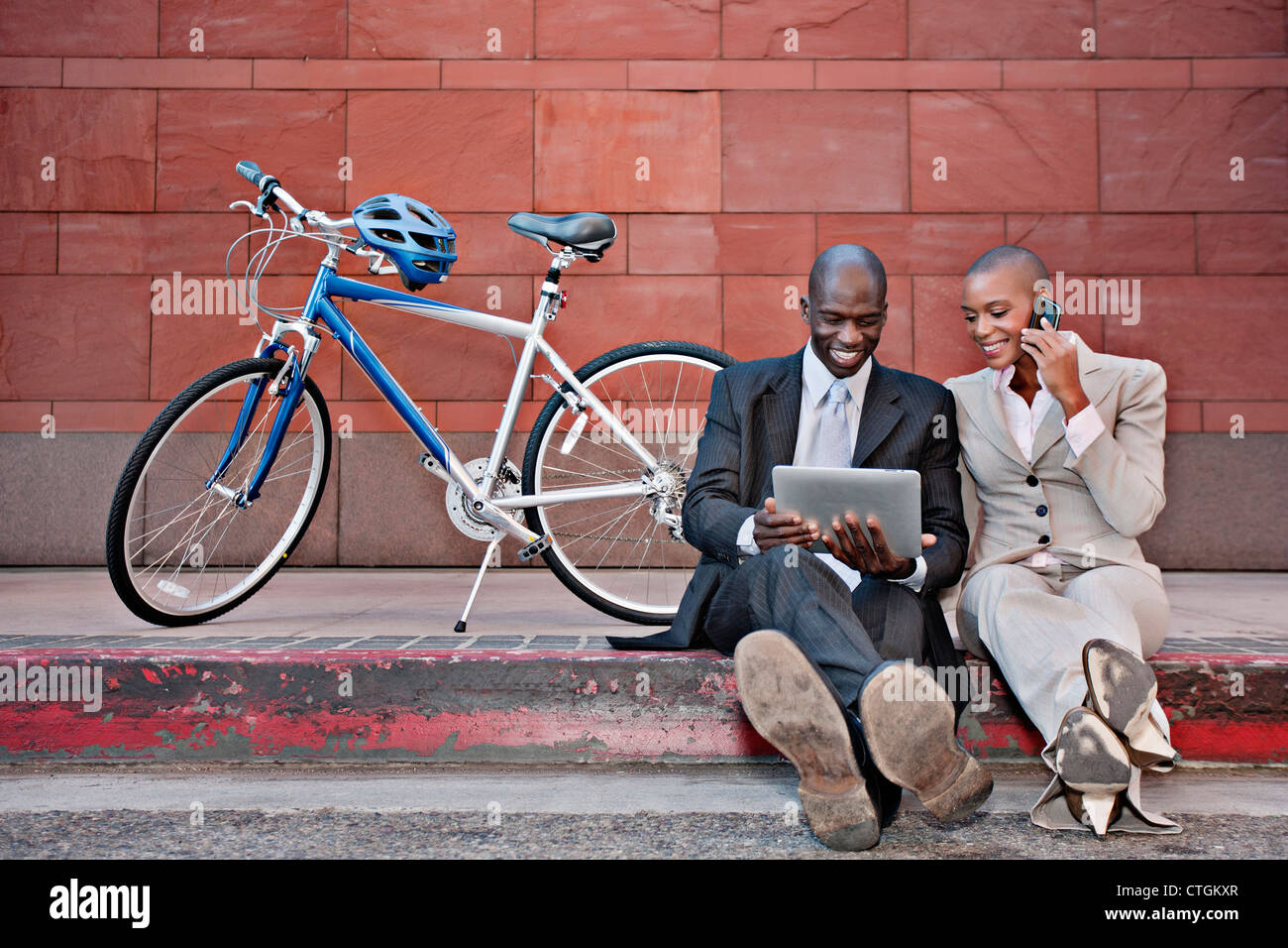 Man sitting on sidewalk curb hi-res stock photography and images - Alamy