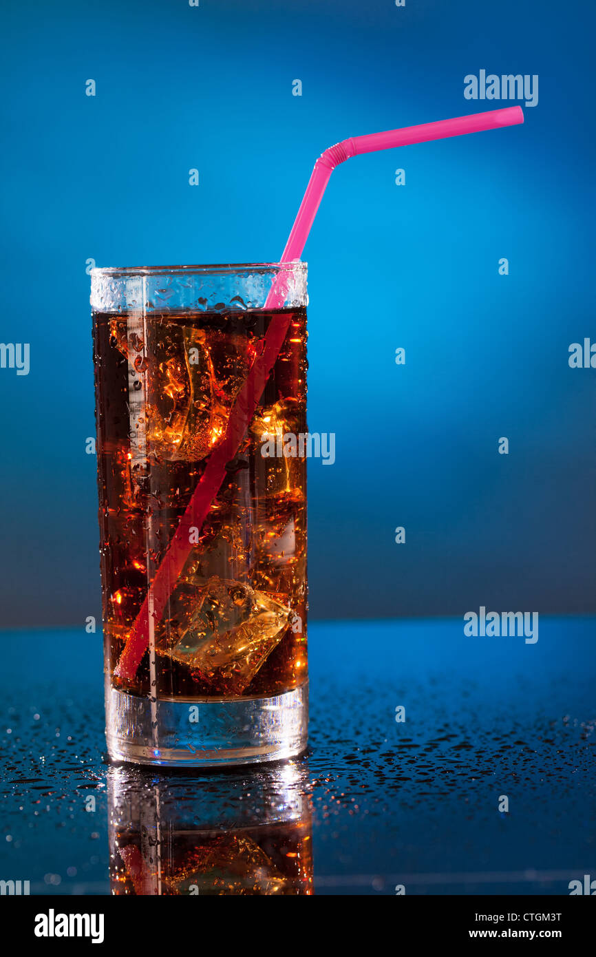 Cold cola in a glass beaker on blue background Stock Photo - Alamy