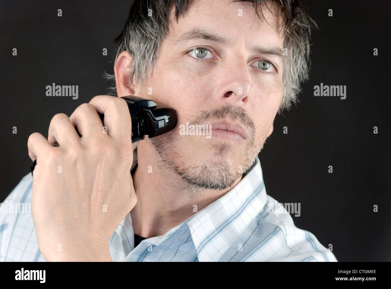 Close-up of a man shaving his goatee with an electric razor Stock Photo ...