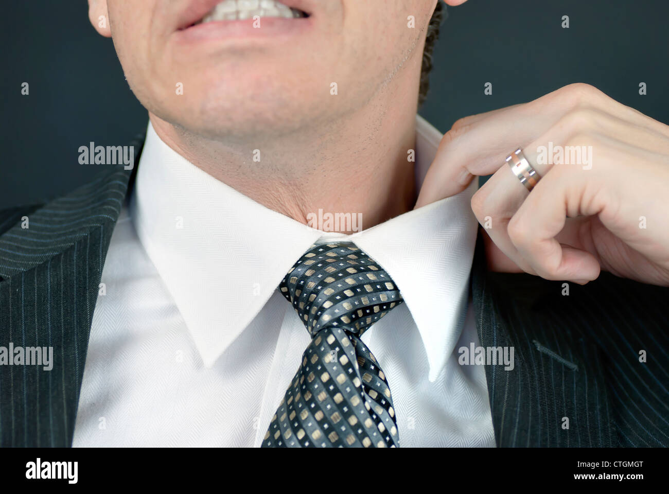 Close-up of an uncomfortable businessman adjusting his collar Stock ...