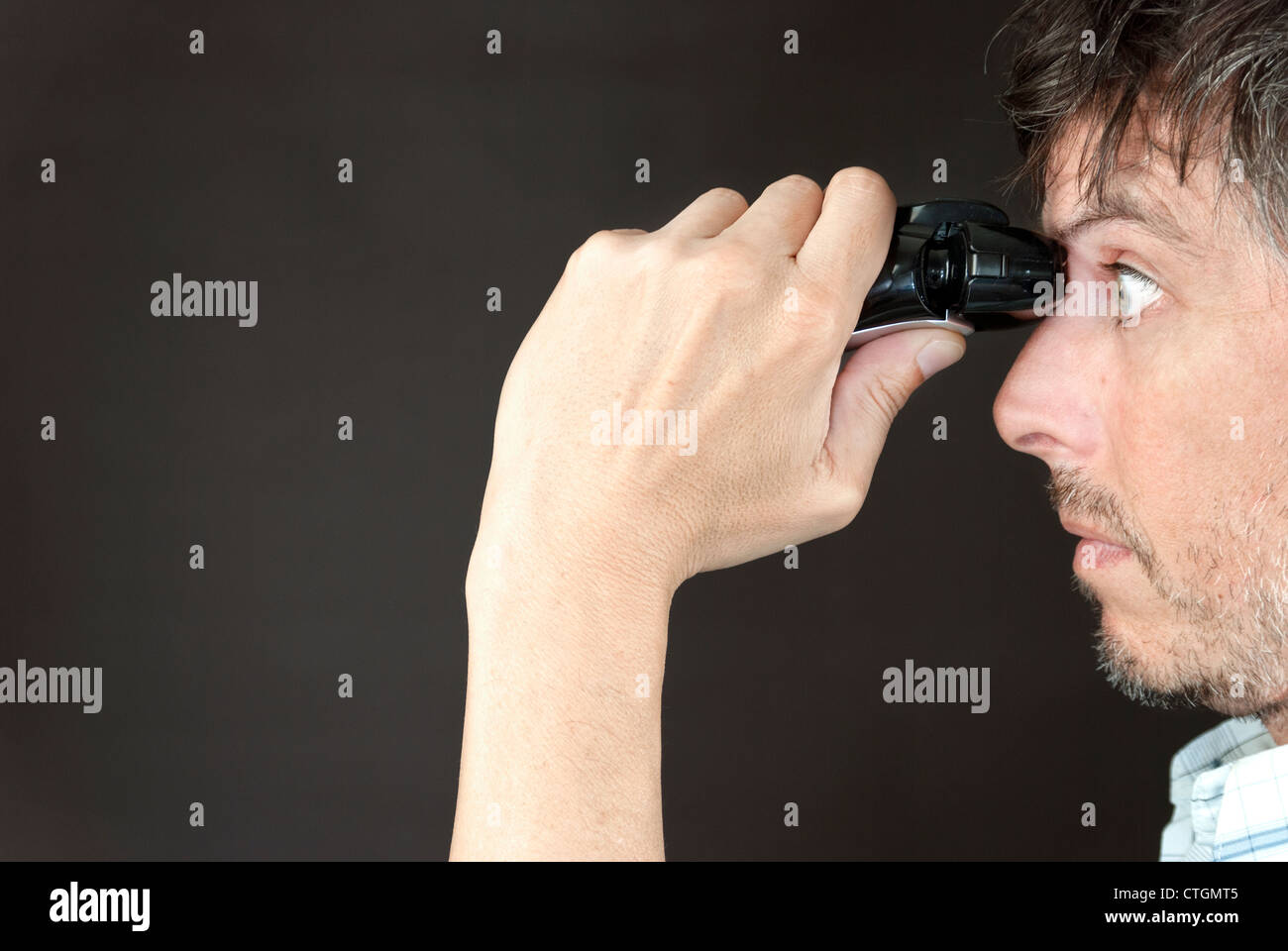 Close-up of a man trimming his monobrow with an electric razor Stock ...