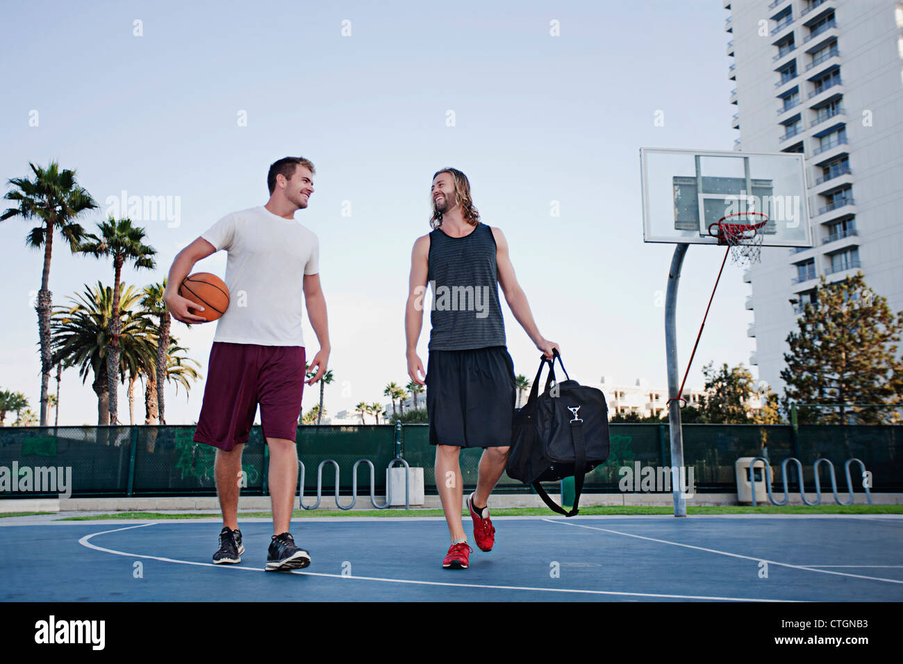 Caucasian men walking on basketball court Stock Photo - Alamy