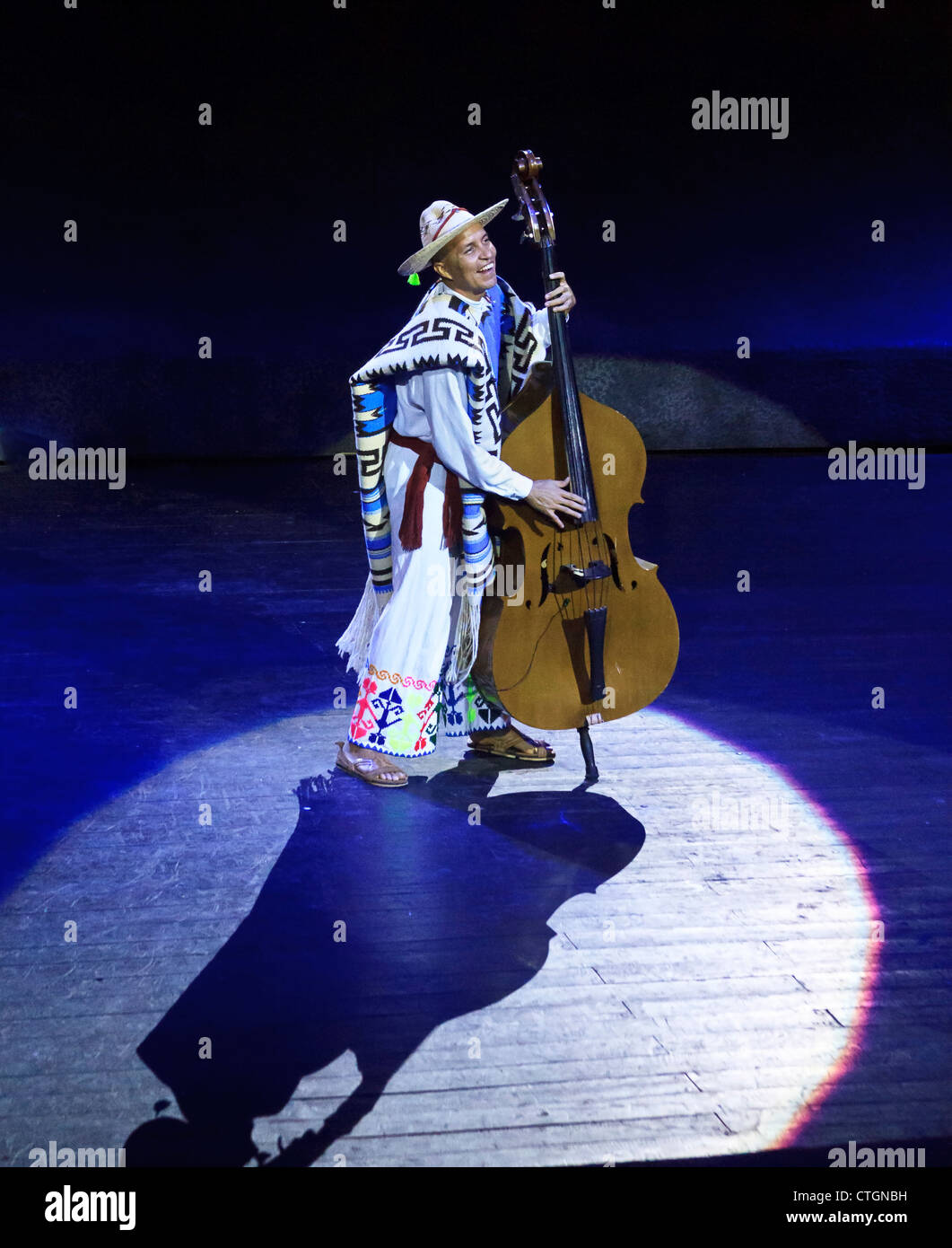 Mexican man plays bass violin at Xcaret's "Mexico Espectacular" show ...