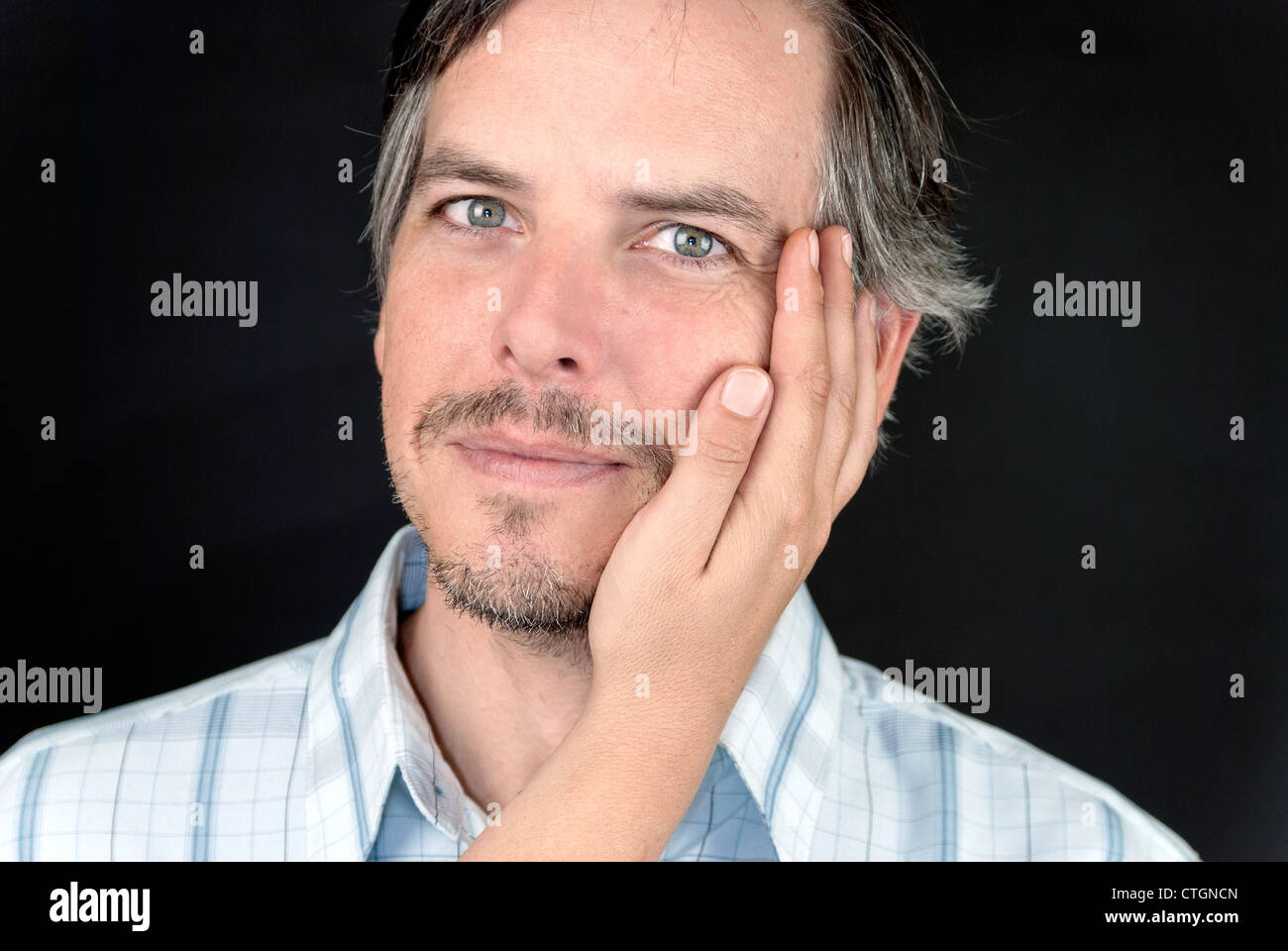 Close-up of a serene man with a woman's hand on his cheek Stock Photo ...