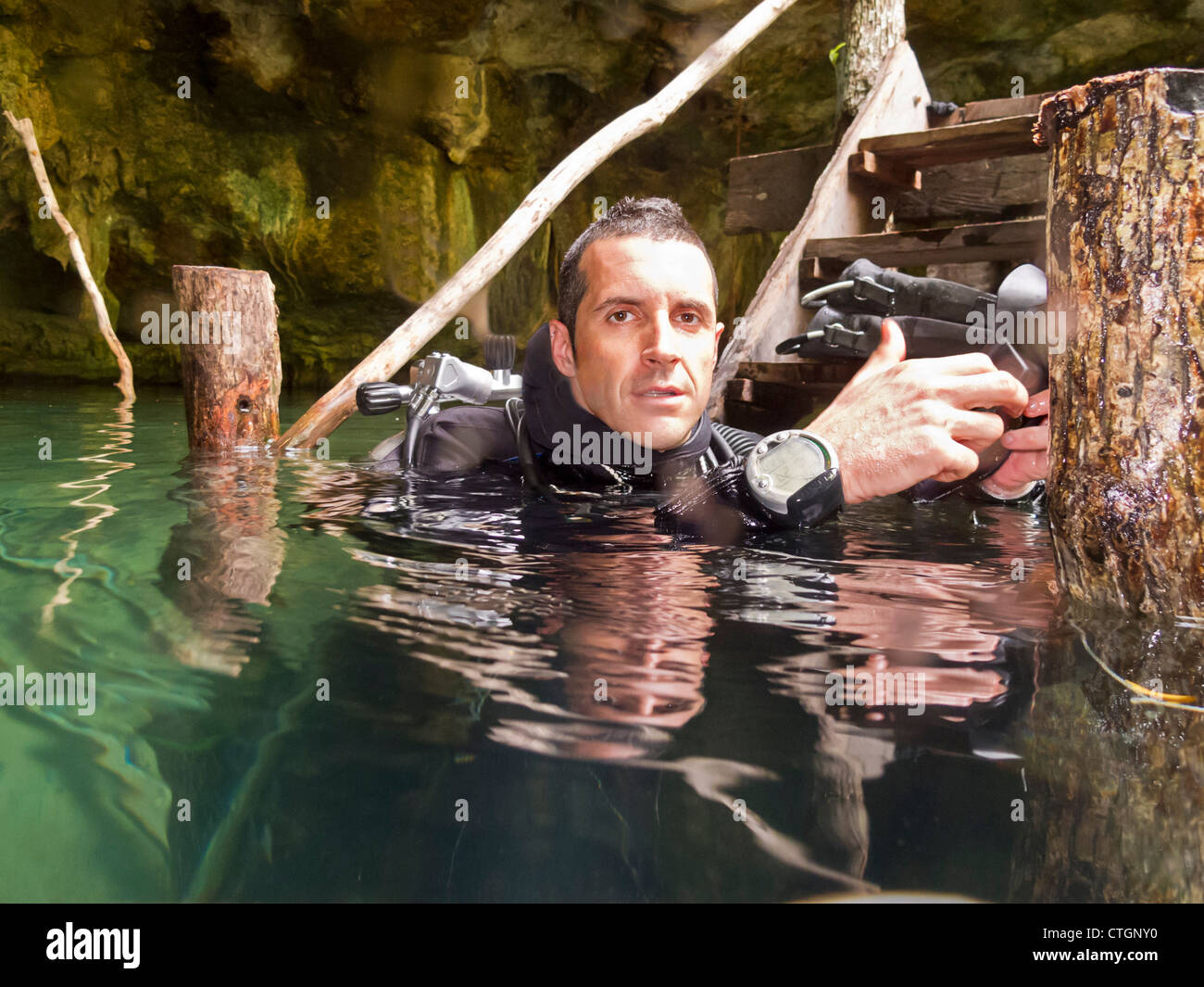 Scuba diver prepares to enter Dream Gate, one of the many cenotes where ...