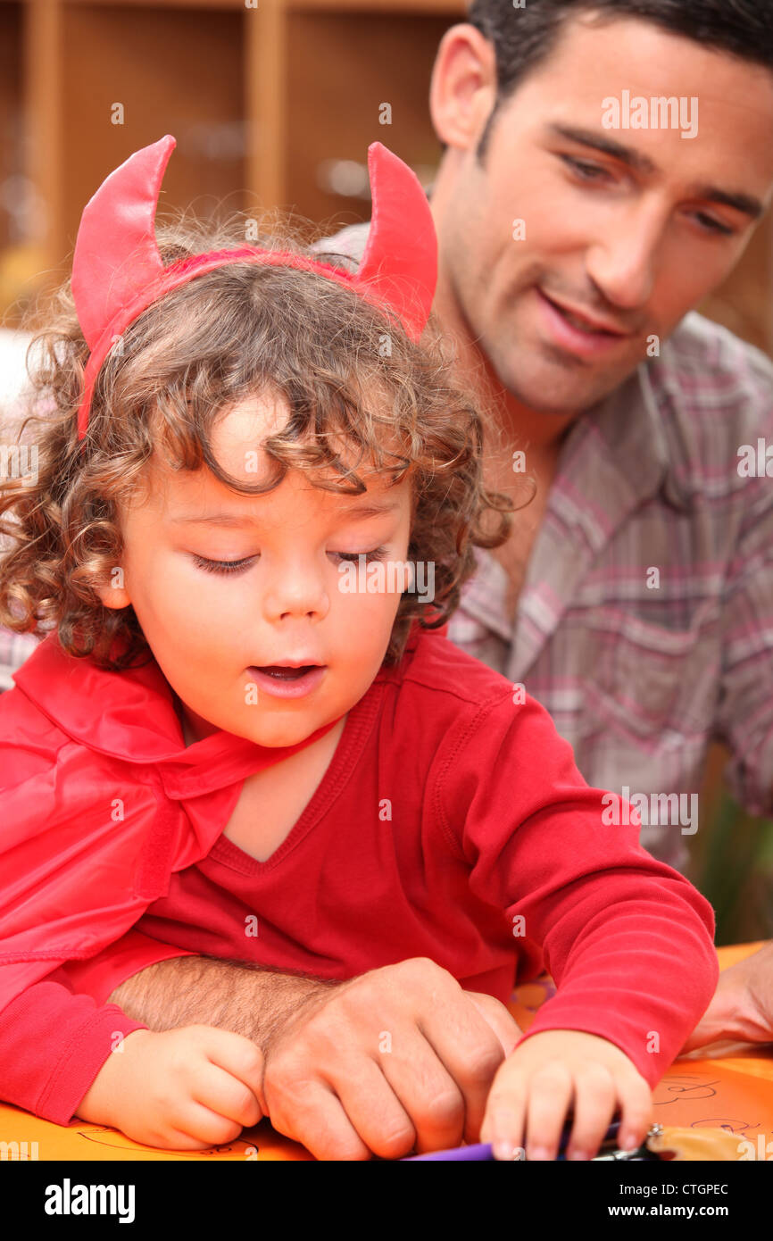 Dad with child dressed as devil Stock Photo - Alamy