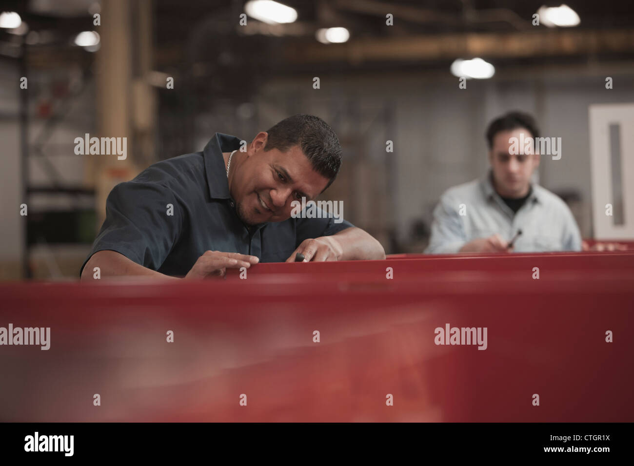 Hispanic worker working in warehouse Stock Photo - Alamy