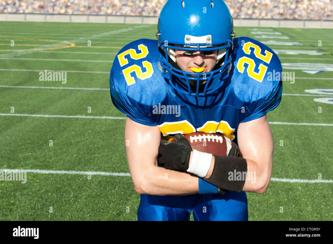 Caucasian football player running with ball Stock Photo - Alamy
