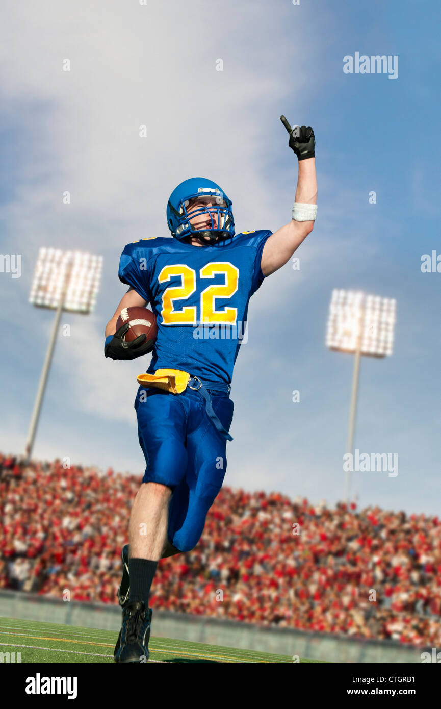 Caucasian football player running with ball Stock Photo - Alamy