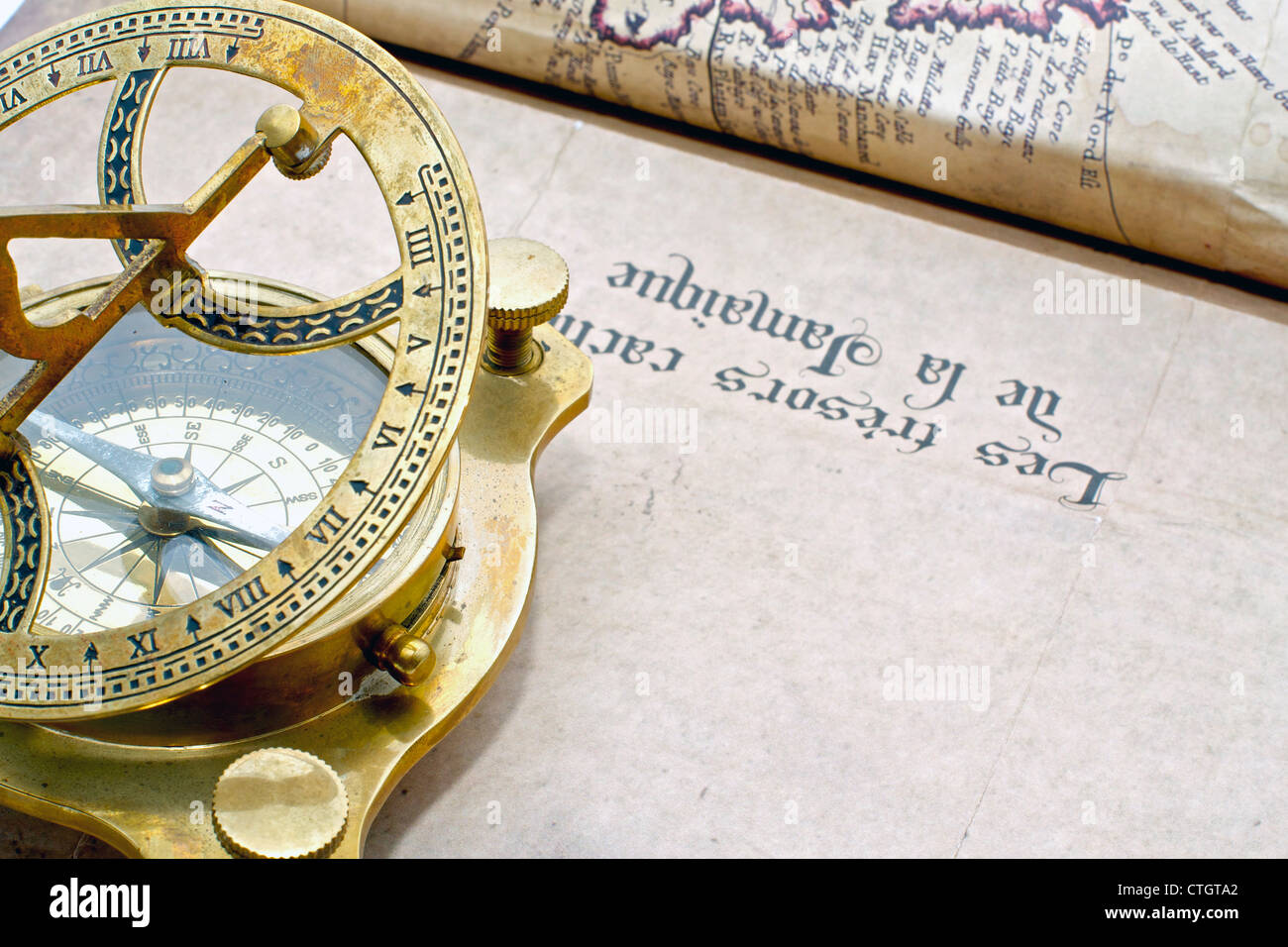 A antique compass on an old map Stock Photo - Alamy