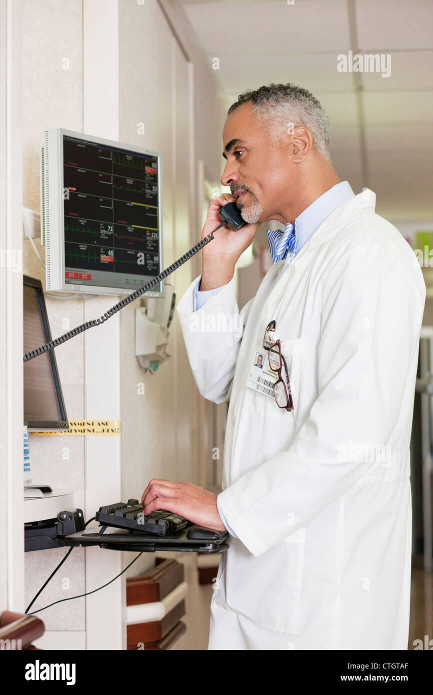 African American doctor talking on telephone in hospital Stock Photo ...