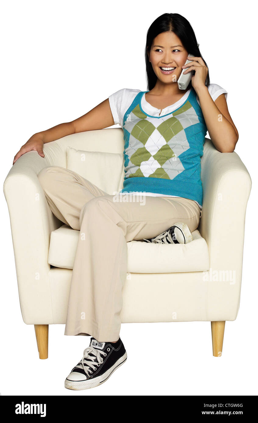Woman sitting in chair talking on telephone Stock Photo - Alamy