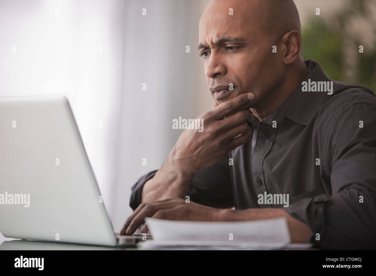 Black man using laptop Stock Photo - Alamy