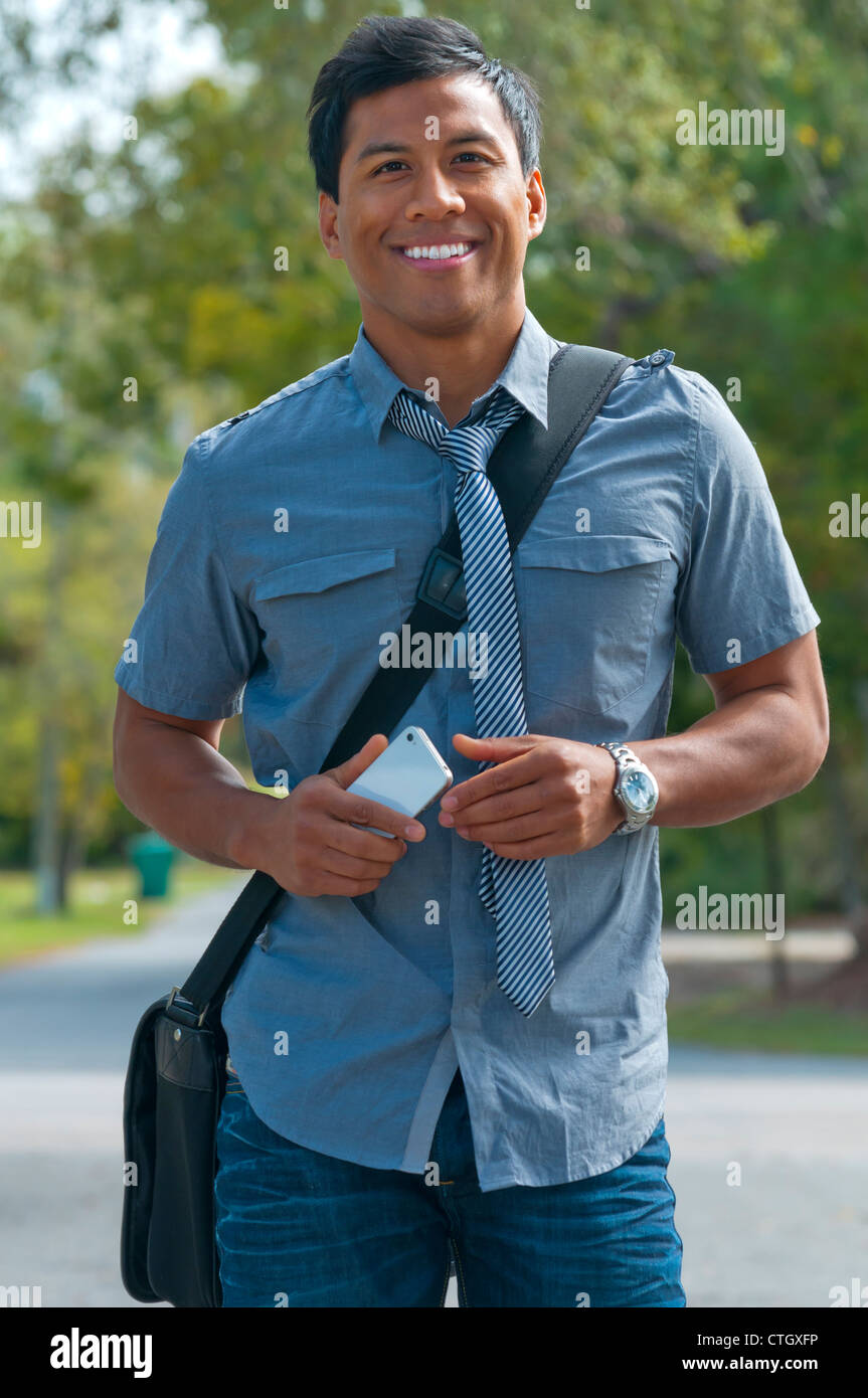 Young Ethnic College Student or teacher with cellular phone heading to ...