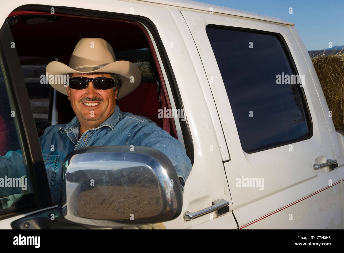 Hispanic man driving truck Stock Photo - Alamy