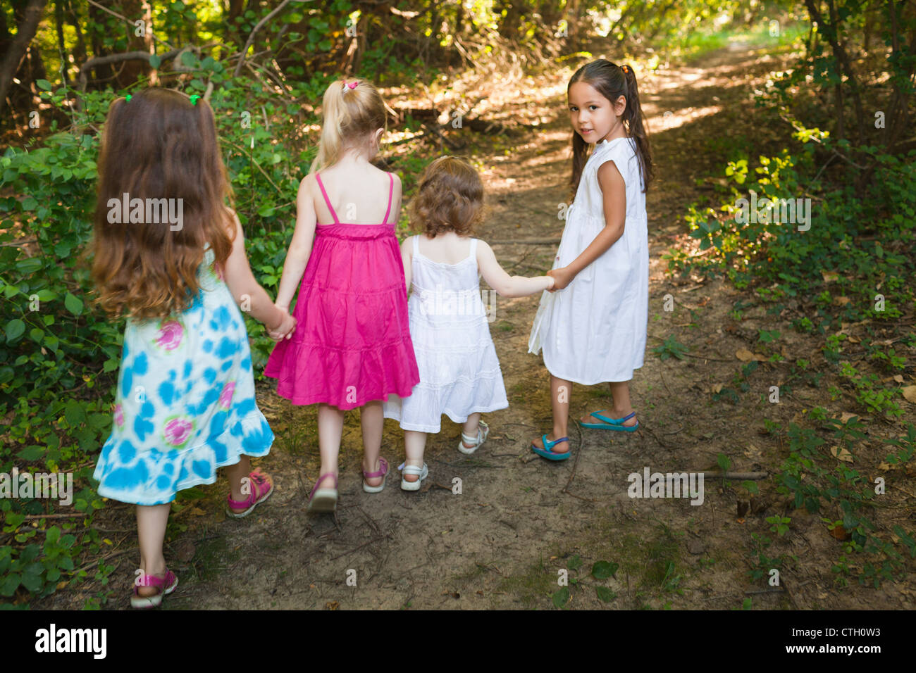 Caucasian girls walking on forest path Stock Photo - Alamy