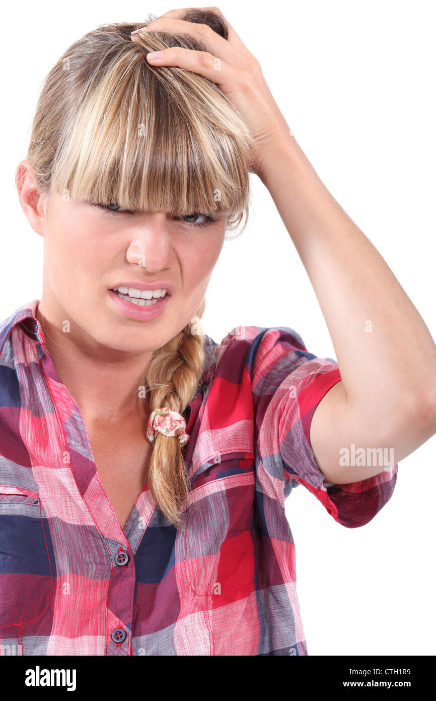 Young woman rubbing her head Stock Photo - Alamy