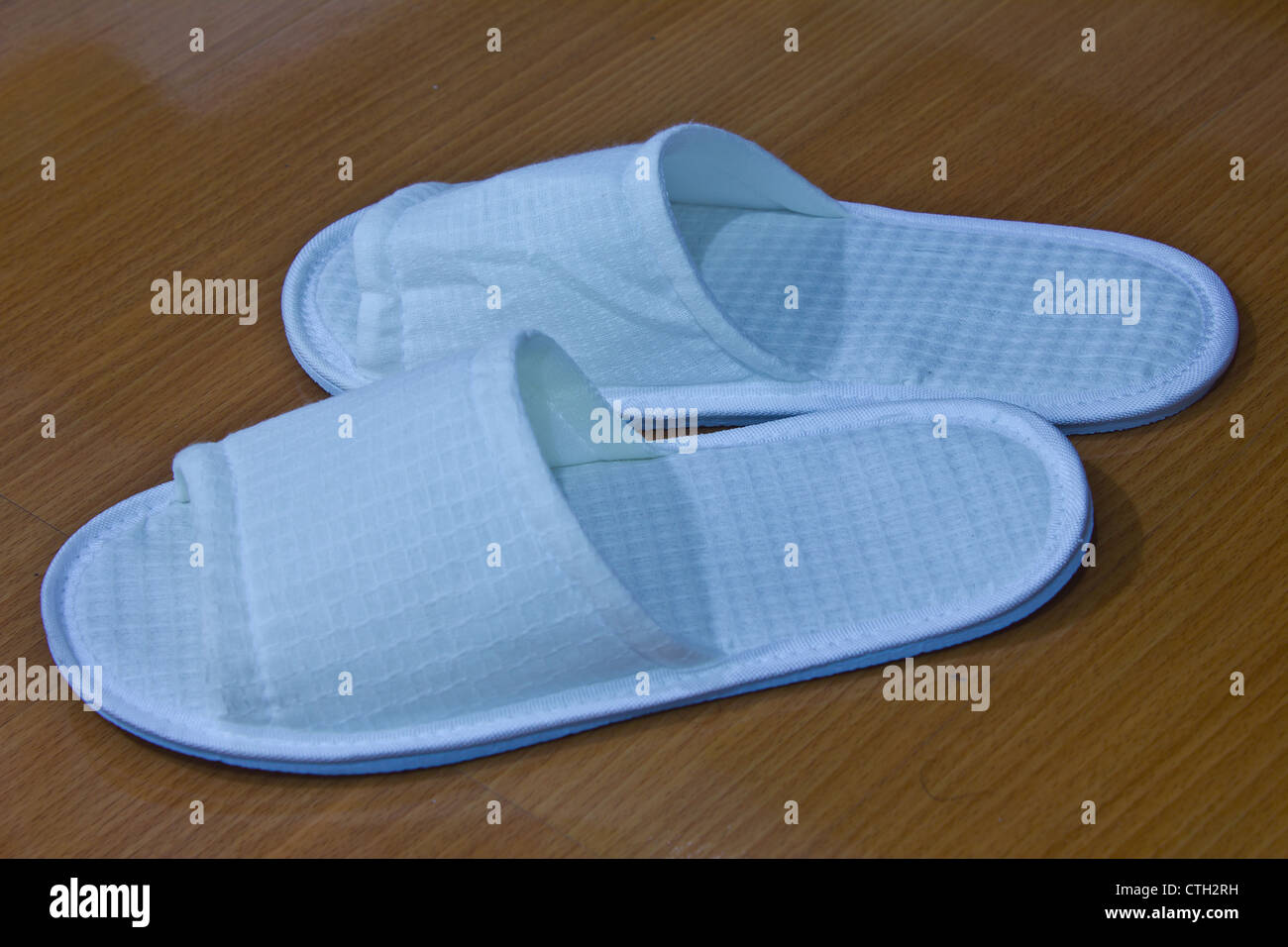 Stock Photo - A pair of white slippers on a Brown background Stock ...