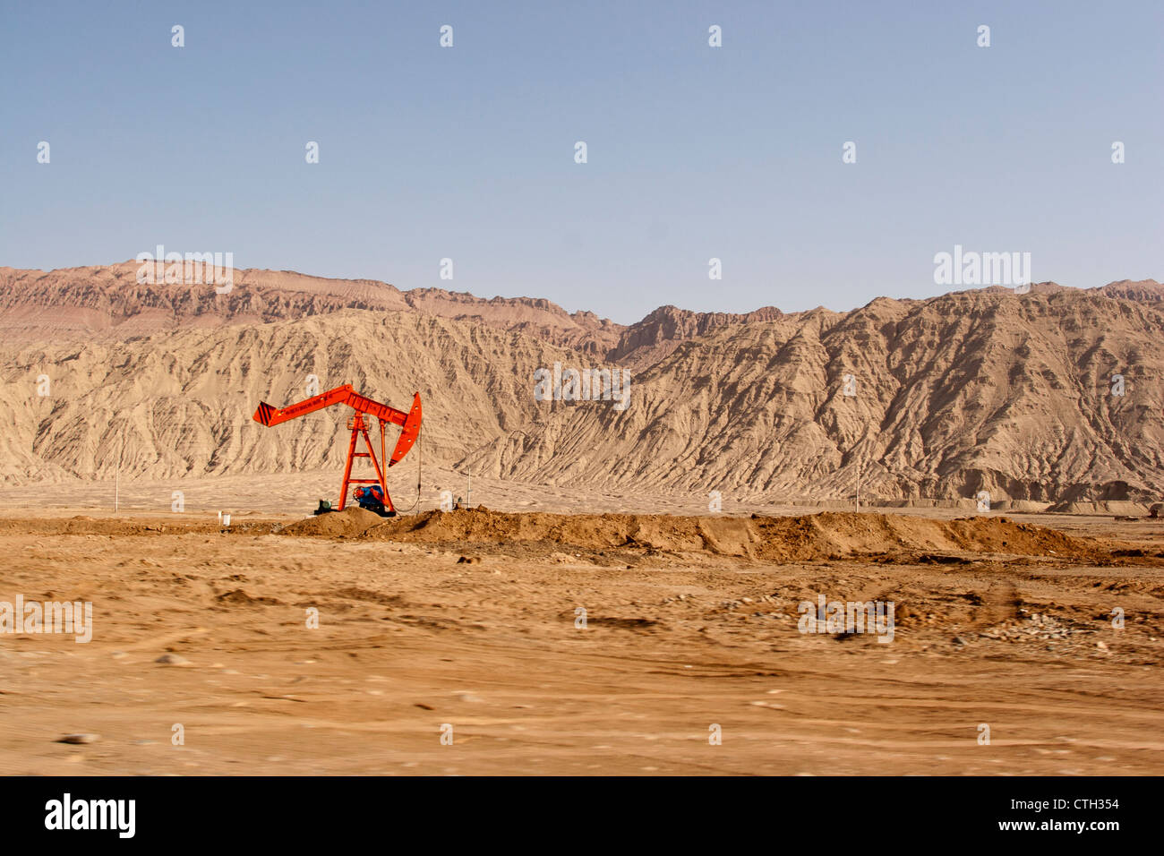 A nodding donkey pump jack, or pumping unit is seen in the desert with ...