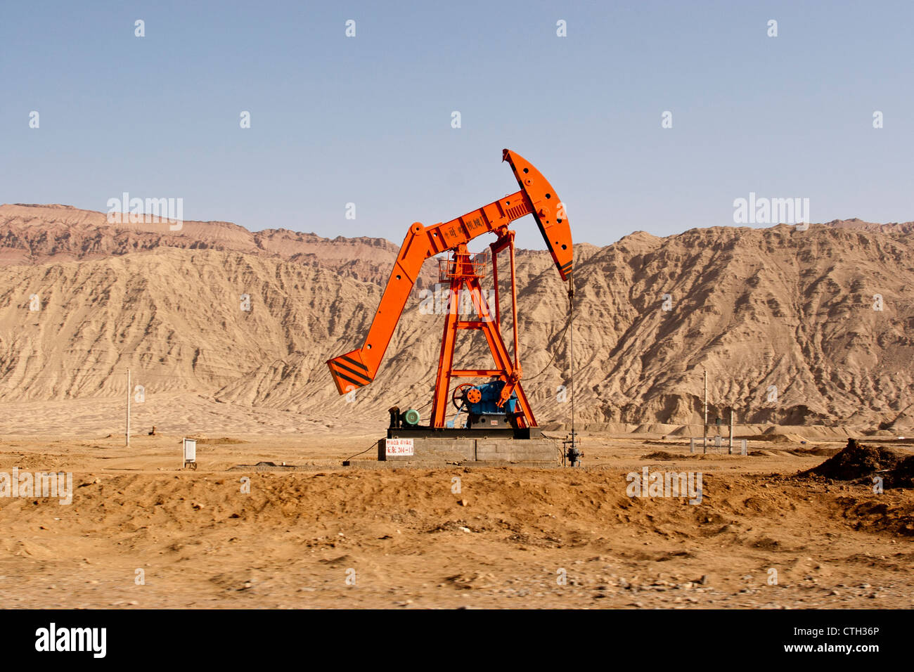 A nodding donkey pump jack, or pumping unit is seen in the desert with ...