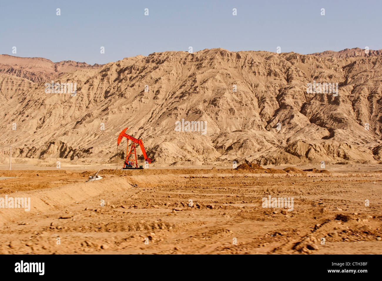 A nodding donkey pump jack, or pumping unit is seen in the desert with ...