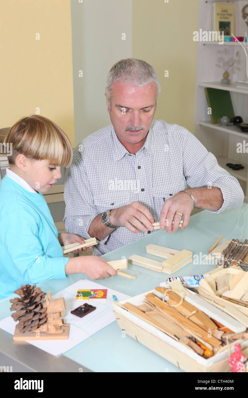 Father and son building a wooden toy Stock Photo - Alamy
