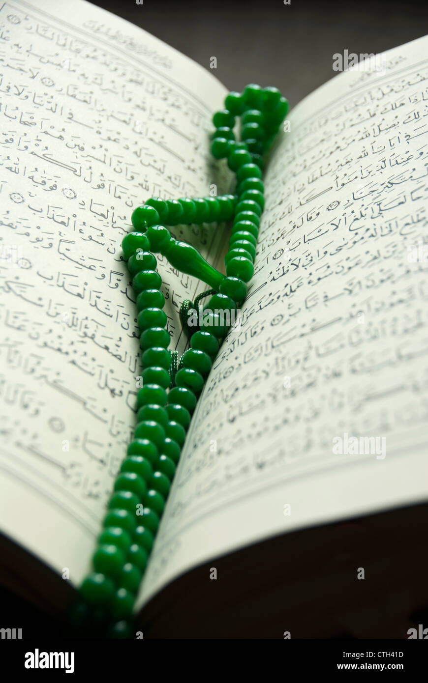 View of a Tasbih or Muslim Praying beads on top of the holy book Koran ...