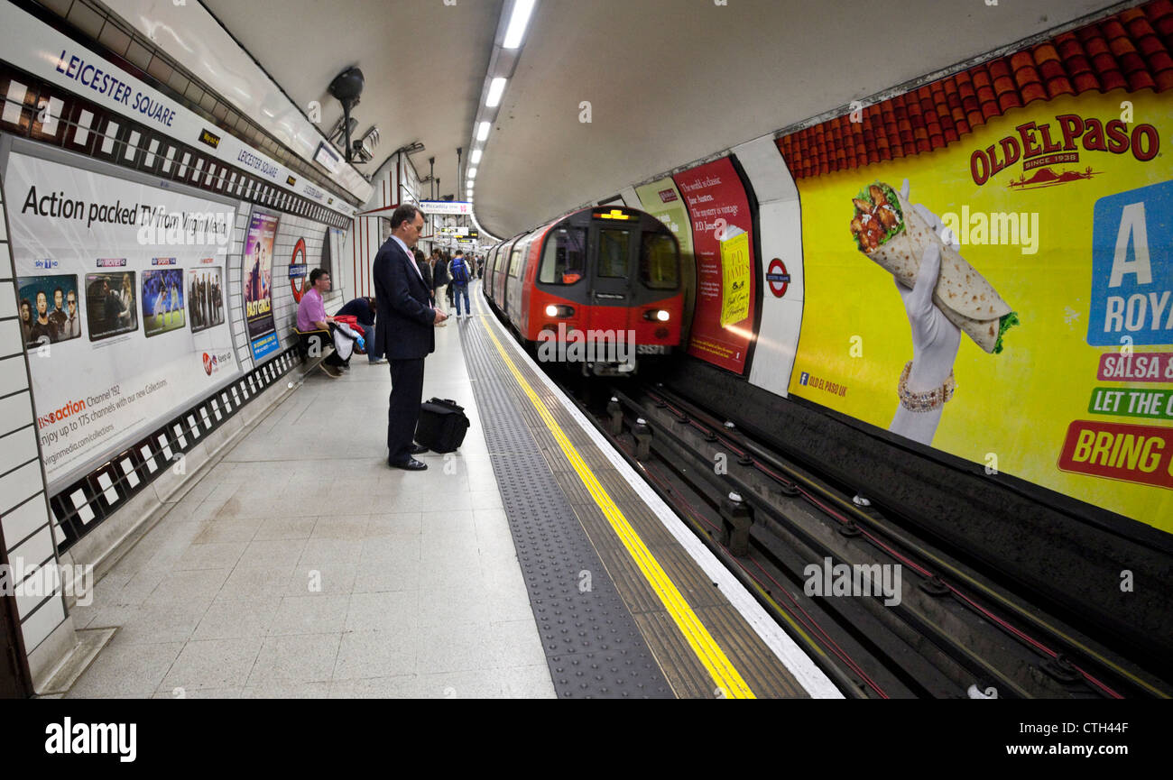 People on the platform waiting for approaching train, Leicester Square ...