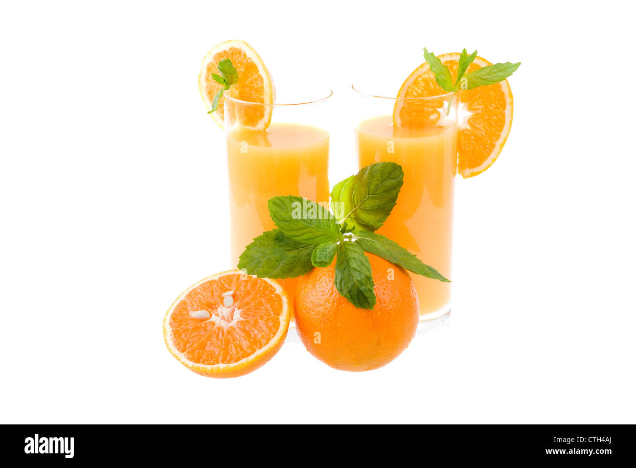 two glasses of orange juice with some oranges Stock Photo - Alamy