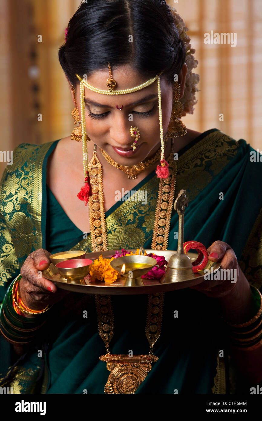 Young bride taking a bow with offerings Stock Photo - Alamy