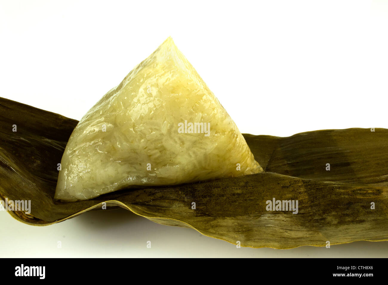 Side profile view of a unwrap rice dumpling on isolated white ...