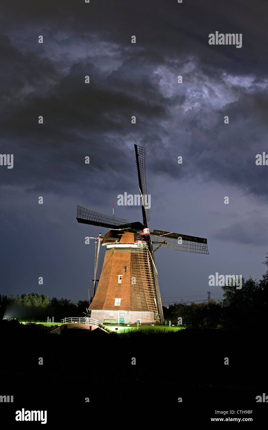 The Netherlands, Kinderdijk, Lit Windmills situated in the ...