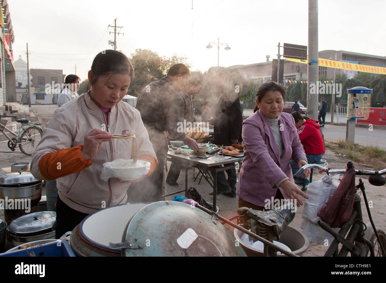 Han Chinese eat breakfast at an outdoor stall in Turpan, Xinjiang ...