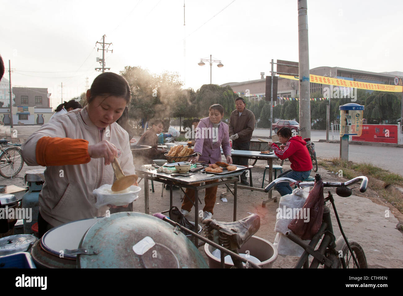 Han Chinese eat breakfast at an outdoor stall in Turpan, Xinjiang ...
