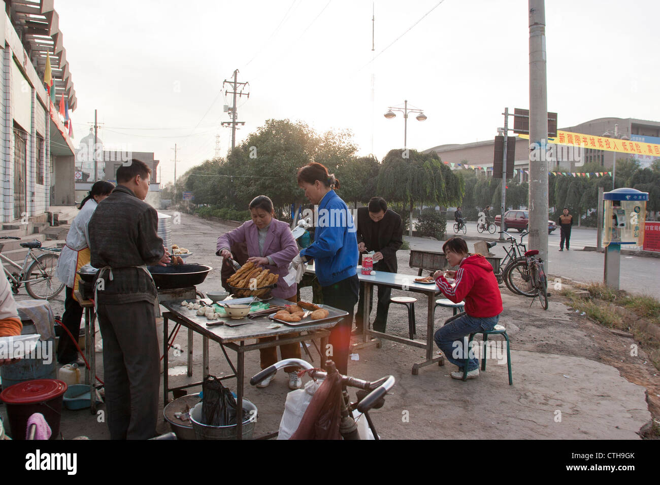 Han Chinese eat breakfast at an outdoor stall in Turpan, Xinjiang ...