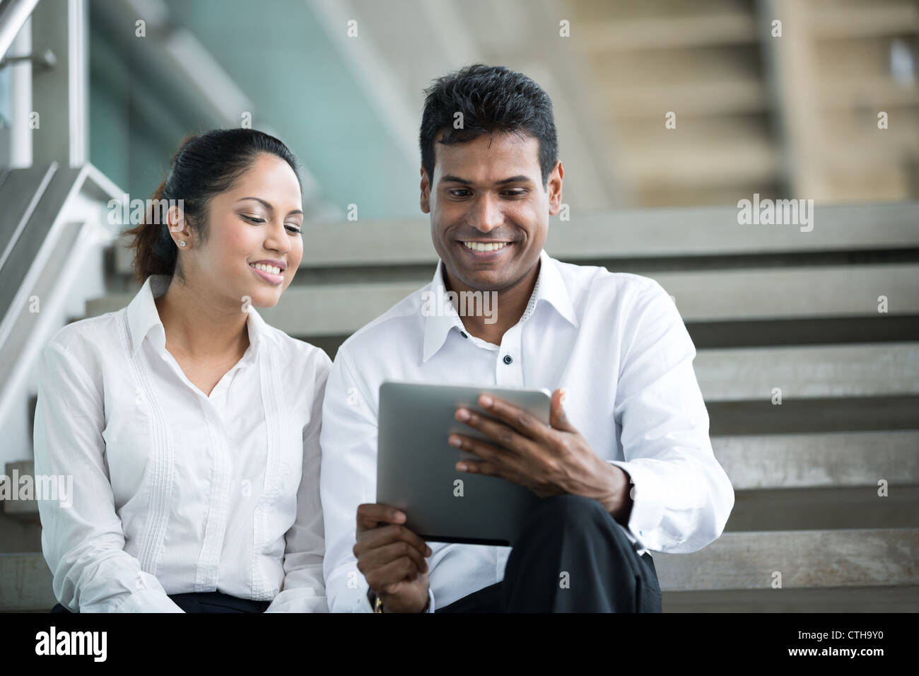 Indian Business people looking at a digital tablet Stock Photo - Alamy