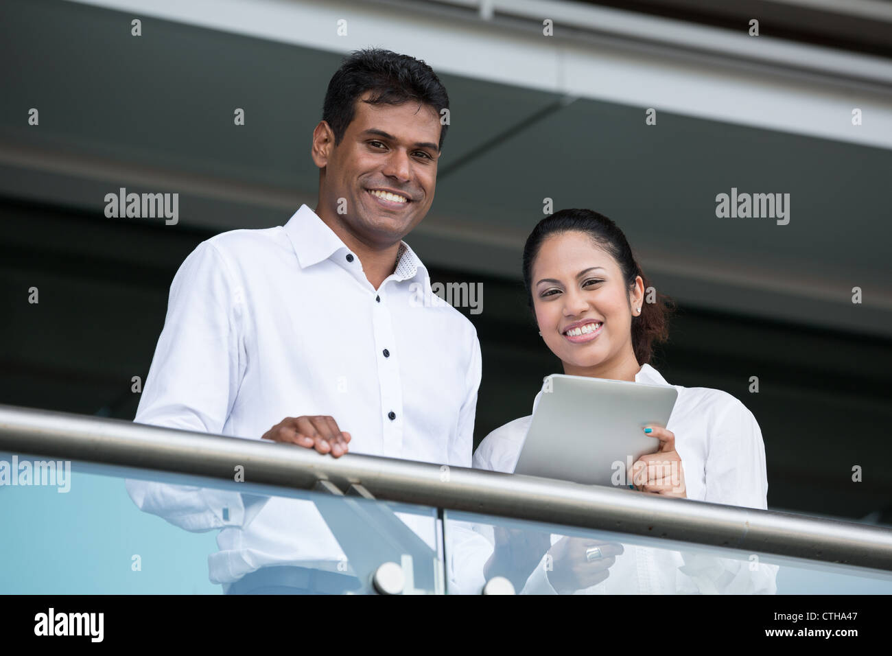 Indian Business people looking at a digital tablet Stock Photo - Alamy