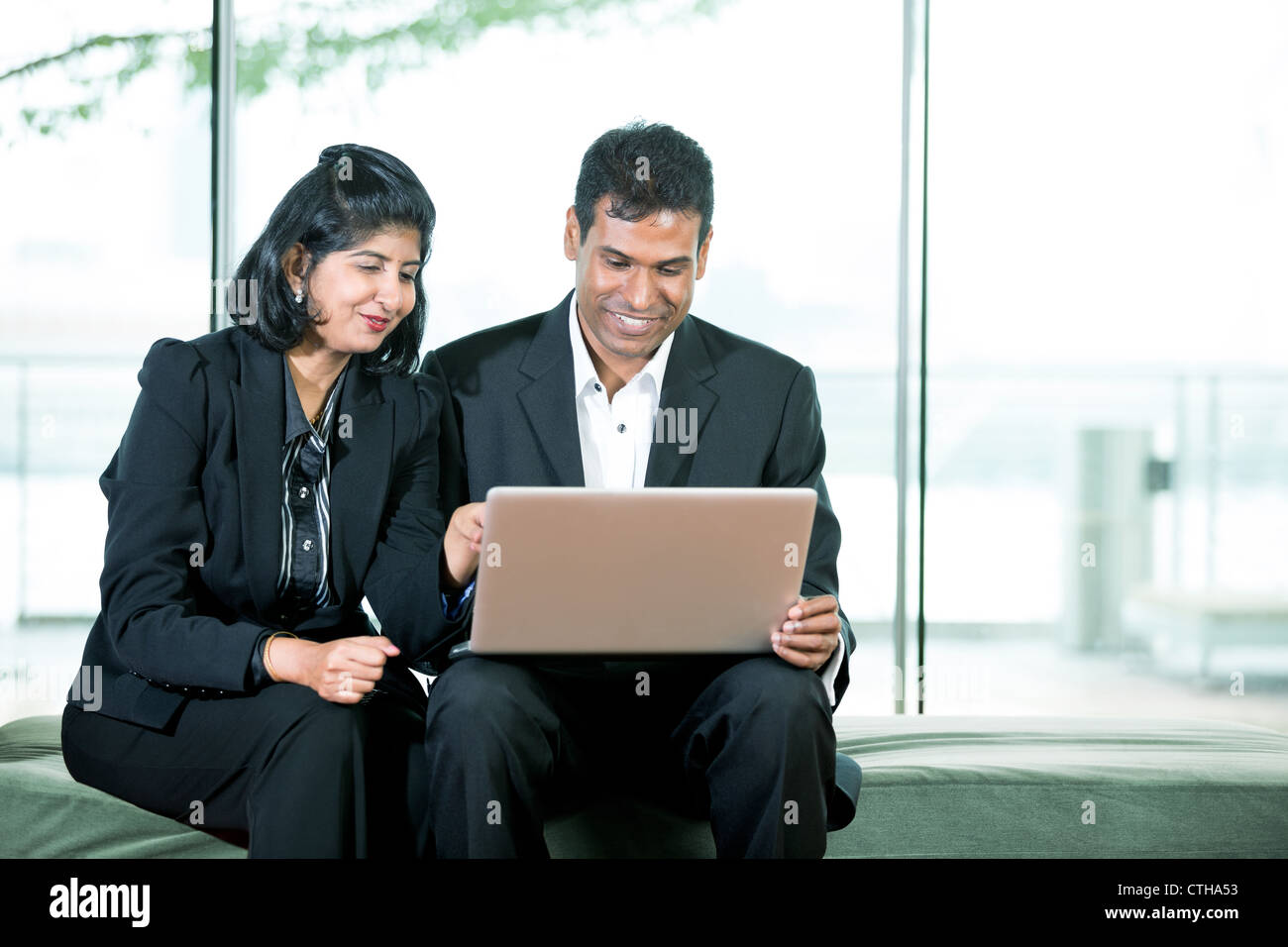 Indian Business colleagues working together on a laptop Stock Photo - Alamy