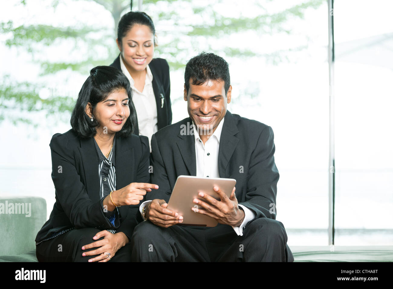 Indian Business people looking at a digital tablet Stock Photo - Alamy