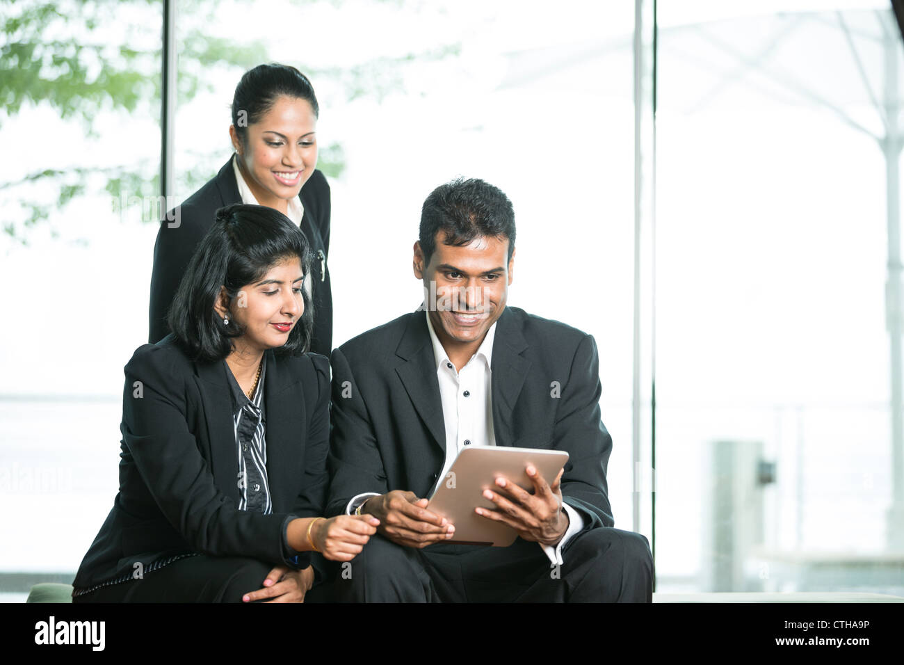 Indian Business people looking at a digital tablet Stock Photo - Alamy