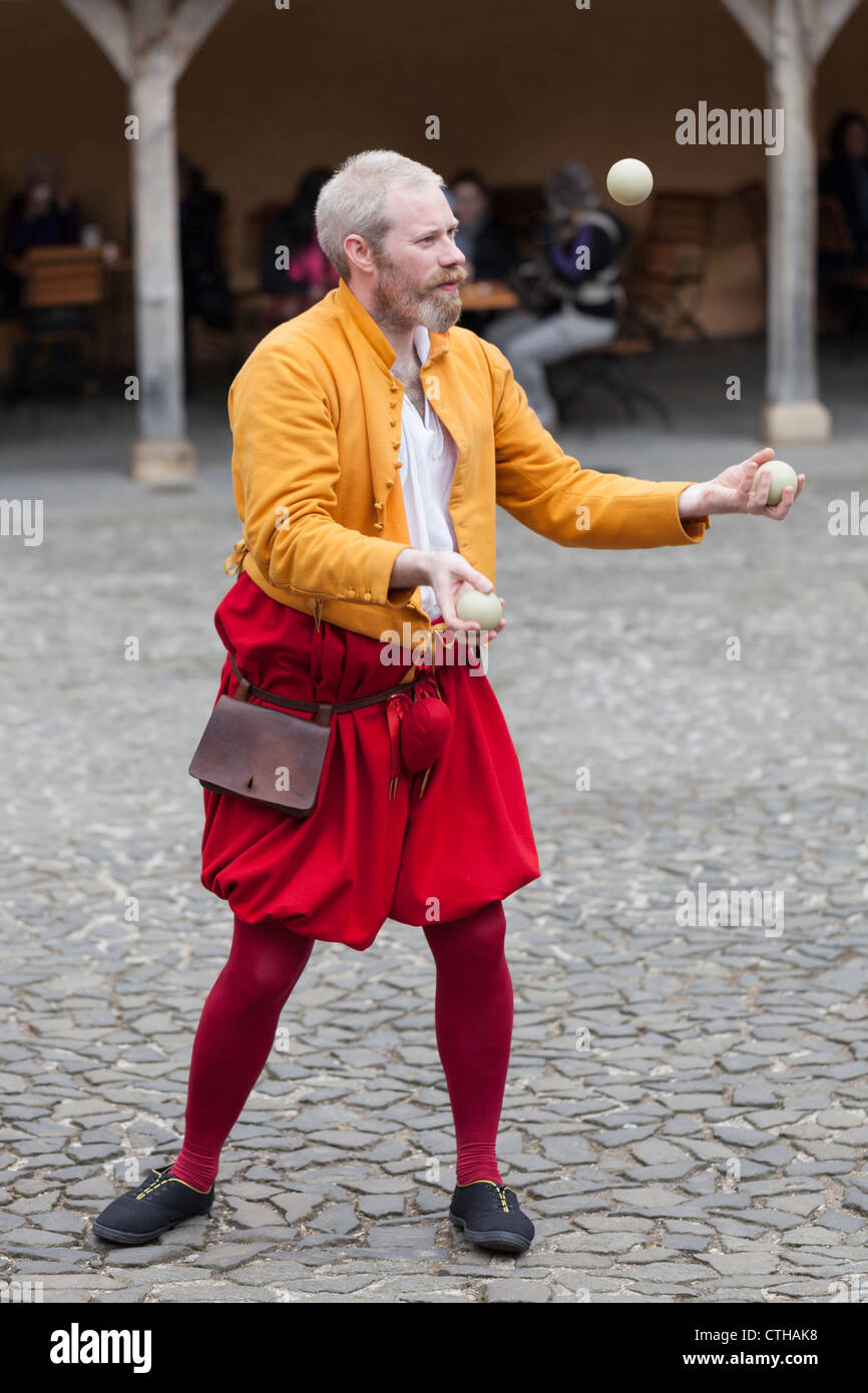 Juggler in historic costume entertains crowd Stock Photo - Alamy