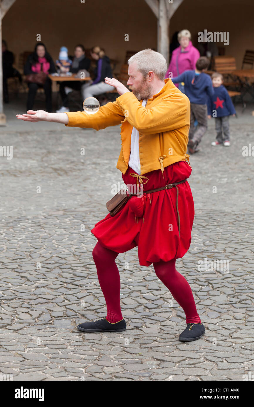 Juggler in historic costume entertains crowd Stock Photo - Alamy