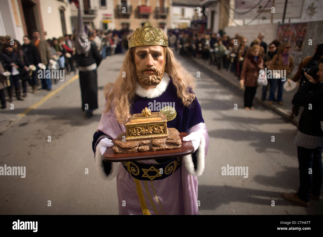 A masked man dressed as a biblical character holds a relic during an ...
