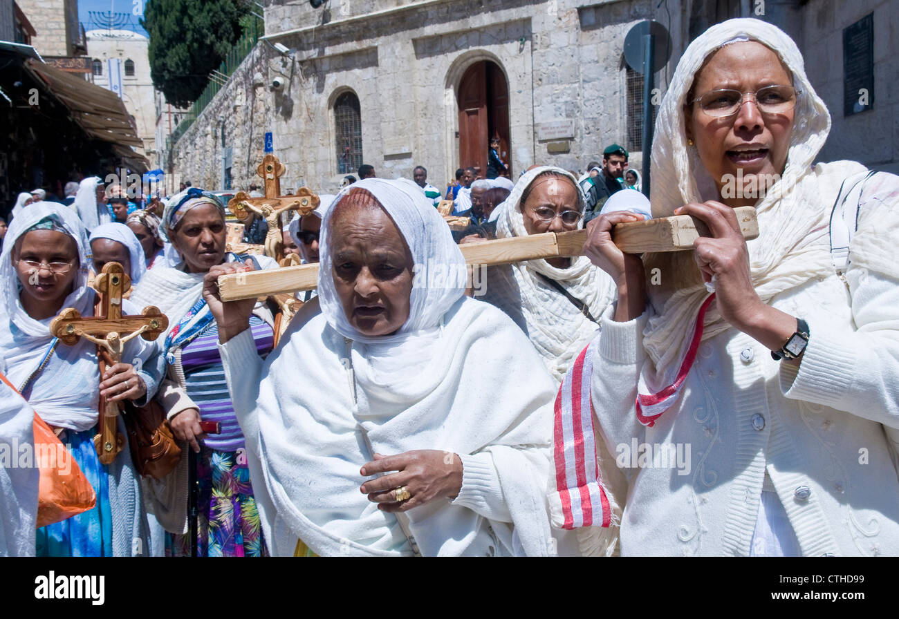 Ethiopian Christian pilgrims carry across along the Via Dolorosa in ...