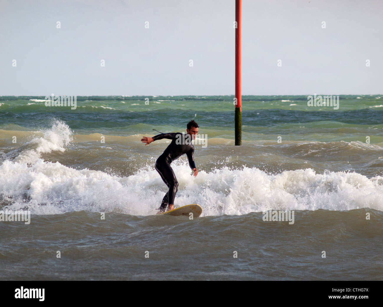 A surfer rides waves in the sea near to Brighton,England Stock Photo ...