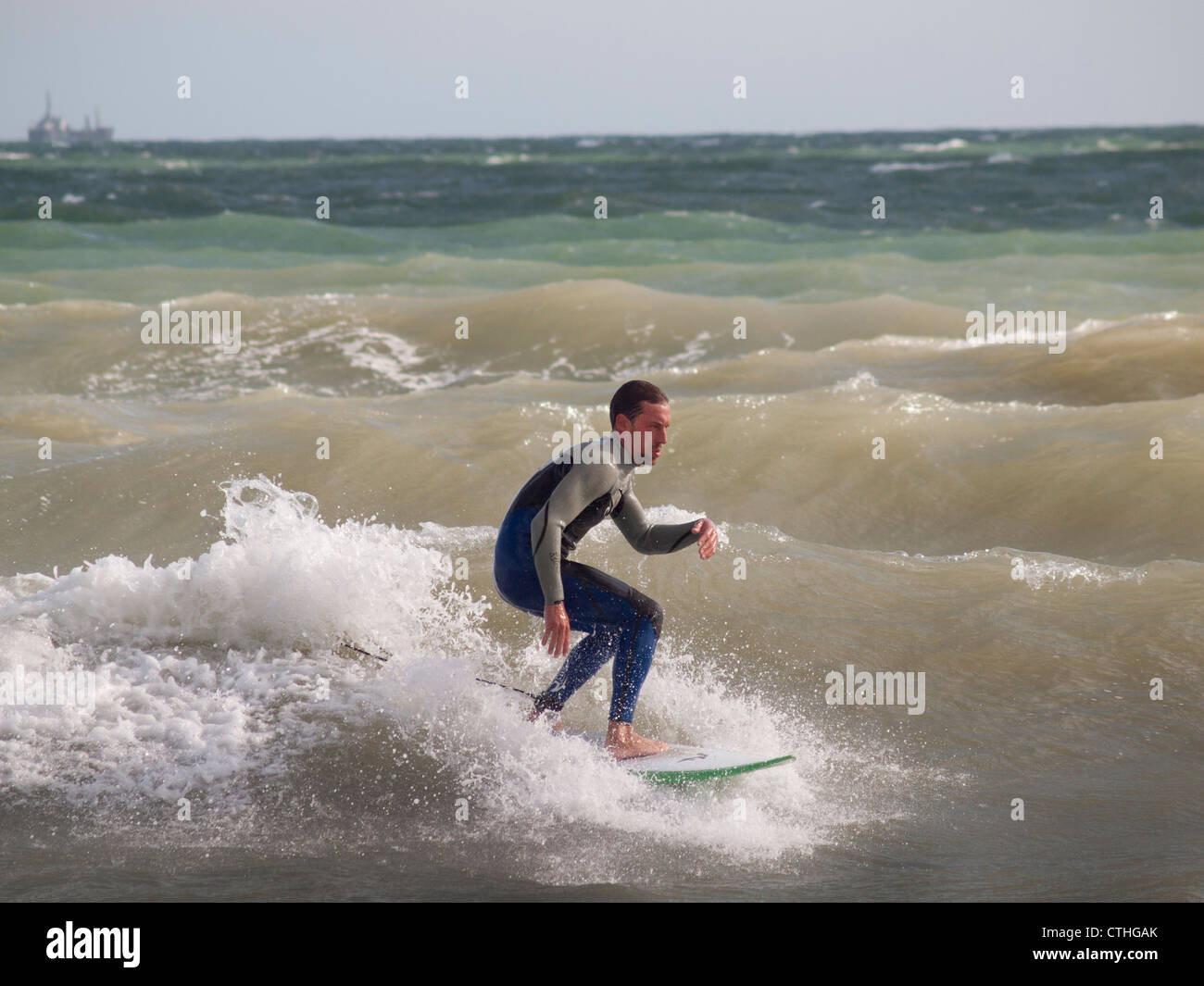 A surfer rides waves in the sea near to Brighton,England Stock Photo ...