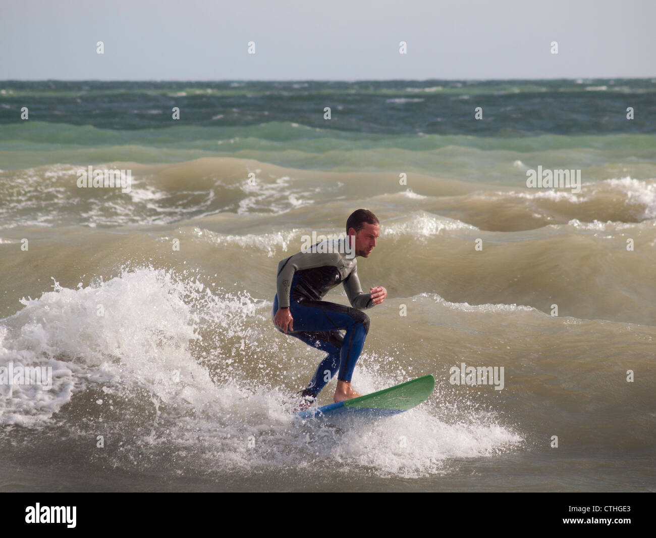 A surfer rides waves in the sea near to Brighton,England Stock Photo ...